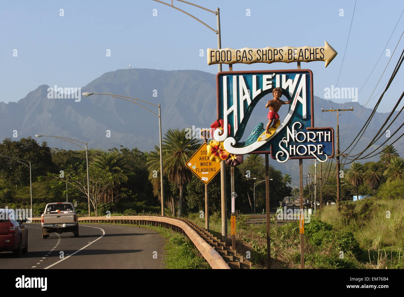 Welcome sign for the town of Haleiwa on the side of a road; Oahu ...
