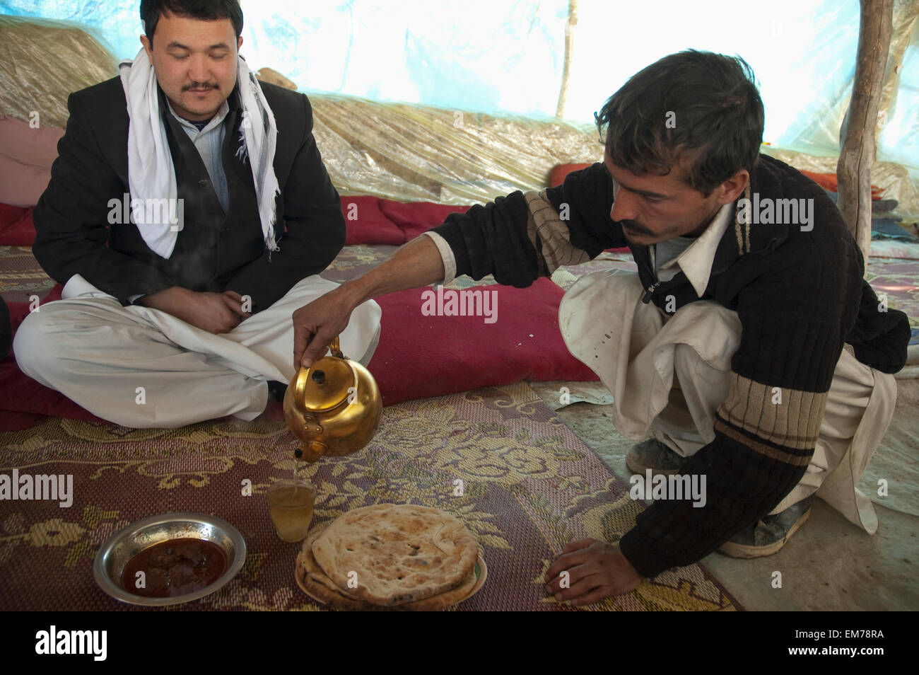 Afghan Man Pouring Tea At A Larger Chaikhana Located By The Side Of The ...