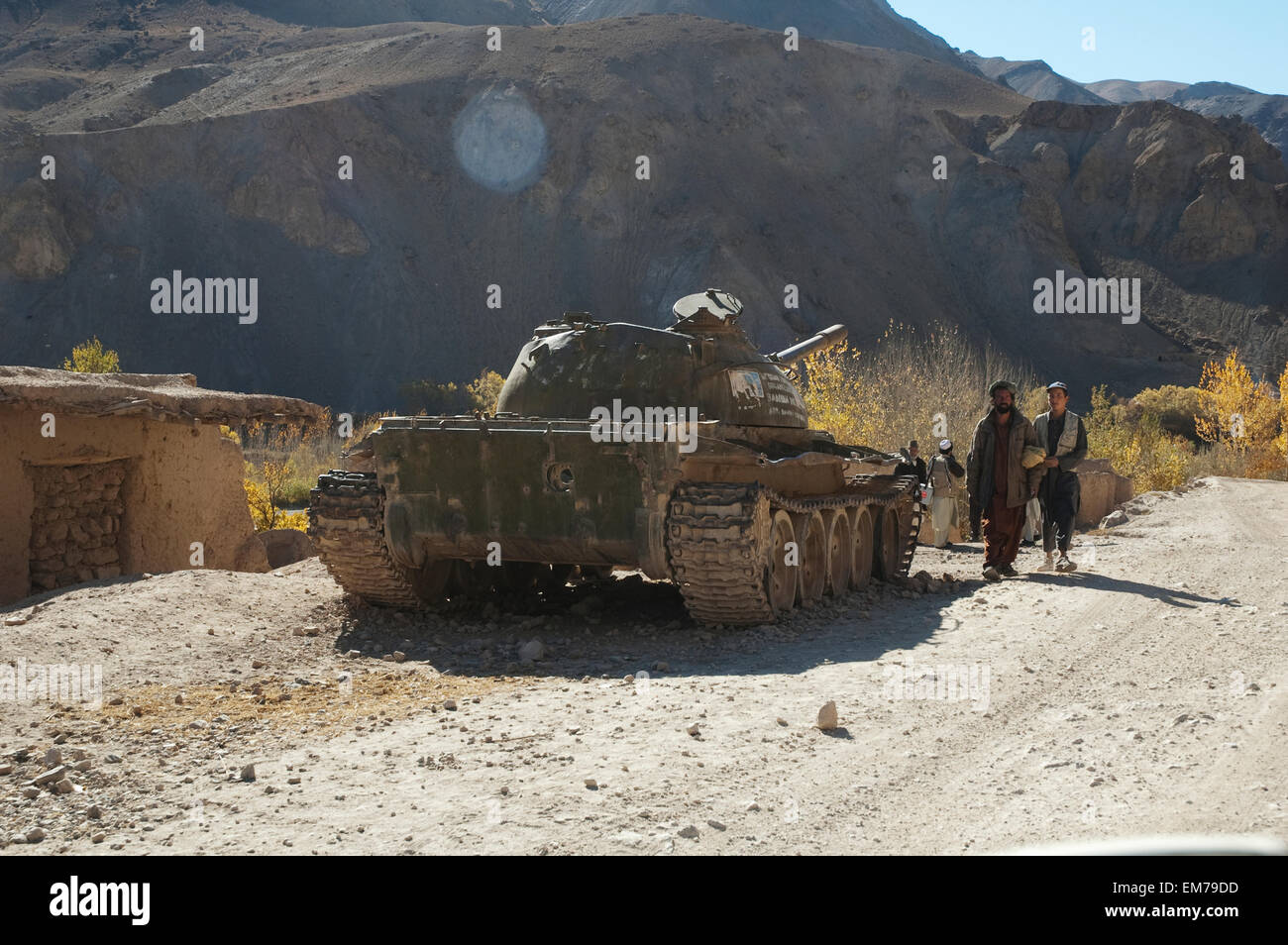 Afghan Men Walk By An Abandoned Soviet Tank In Shekh Ali, Parwan ...