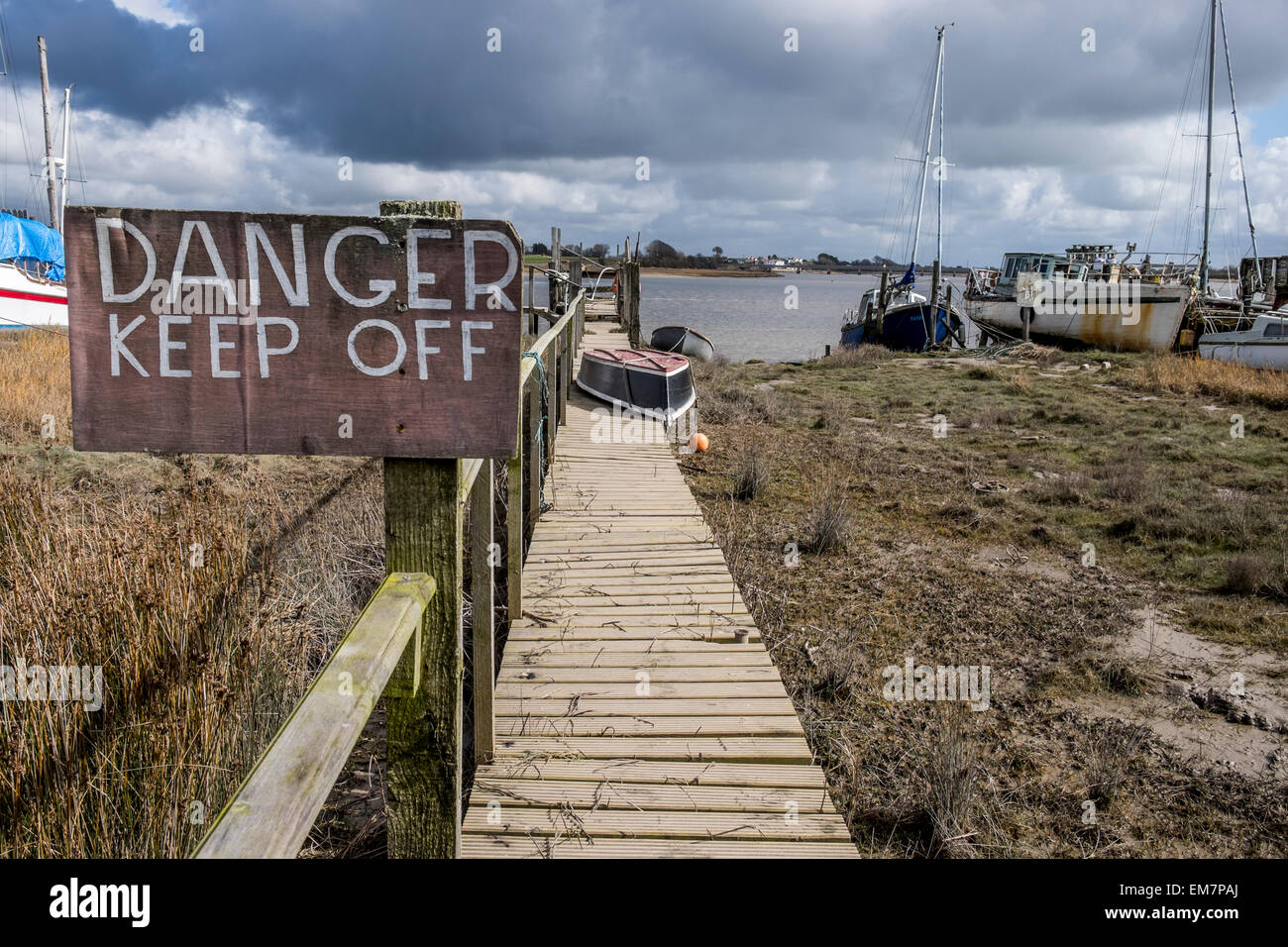 A large Danger Keep Off sign at the end of the Jetty leading to the sea ...