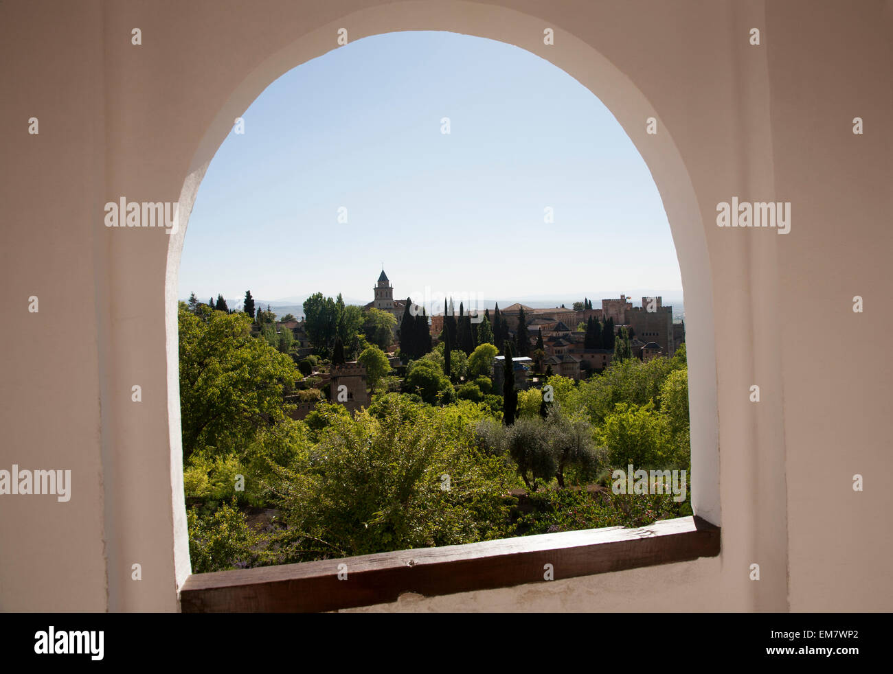 Arched decorated Moorish stone window looking over gardens, Generalife ...