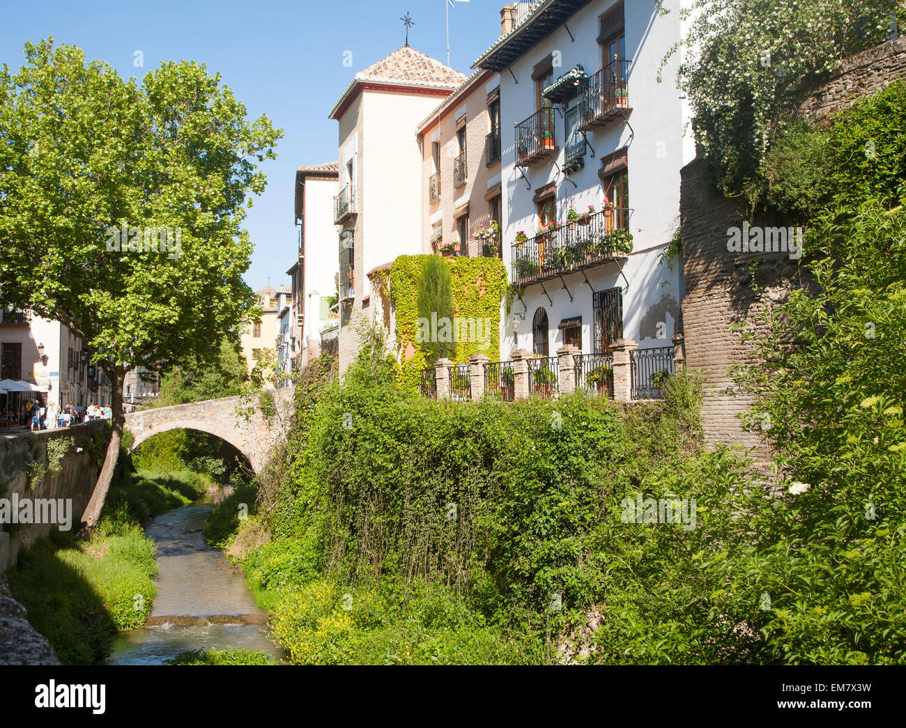Historic stone bridge crossing the River Rio Darro, Granada, Spain ...