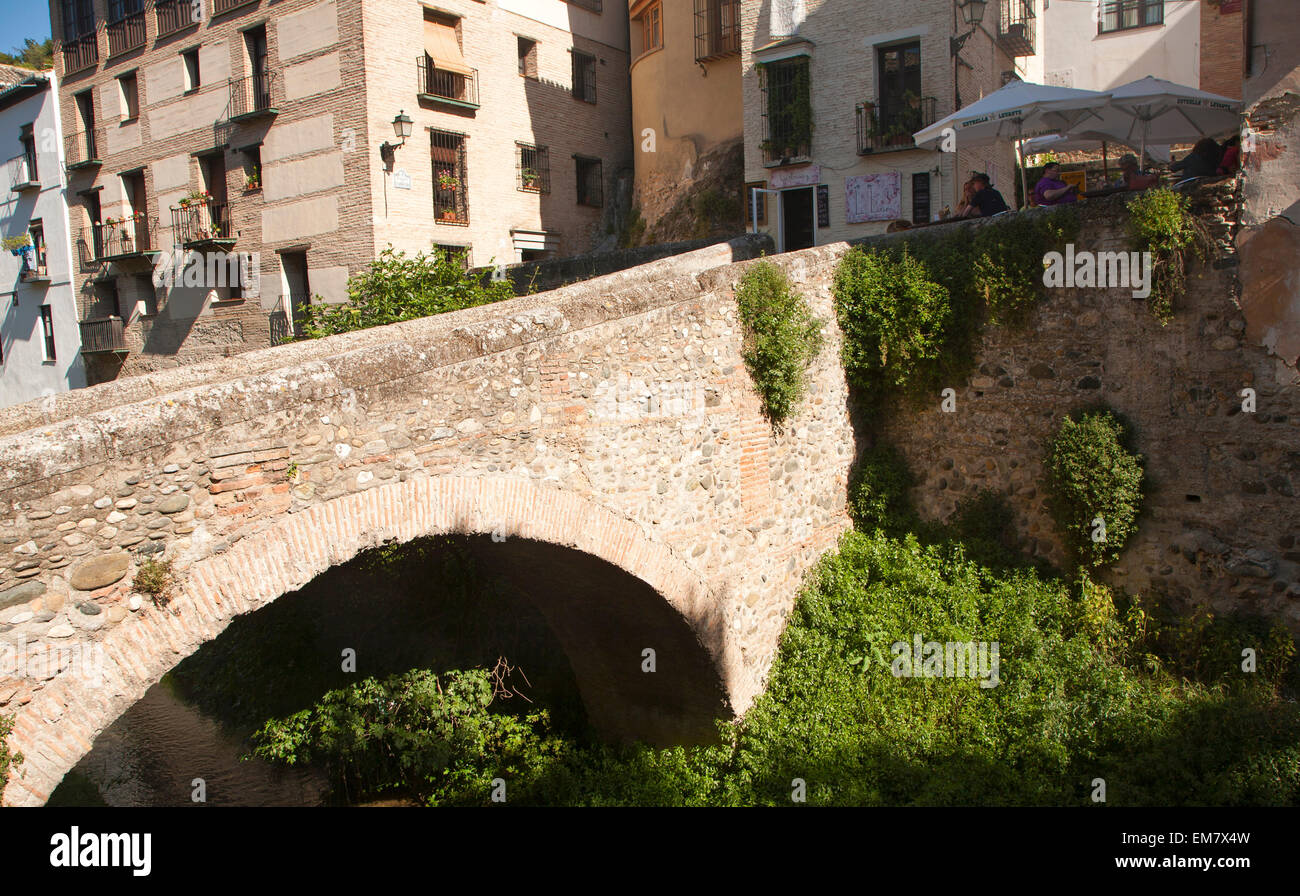 Historic stone bridge crossing the River Rio Darro, Granada, Spain ...