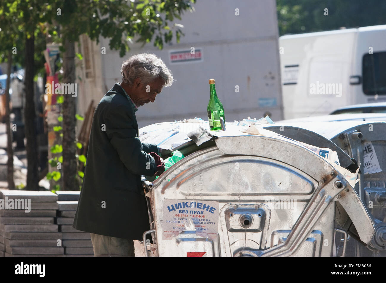 Man sifting through a rubbish bin, Sofia, Bulgaria Stock Photo - Alamy