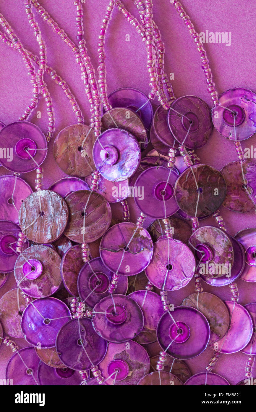 purple mauve coloured beads necklace set on purple mauve background ...