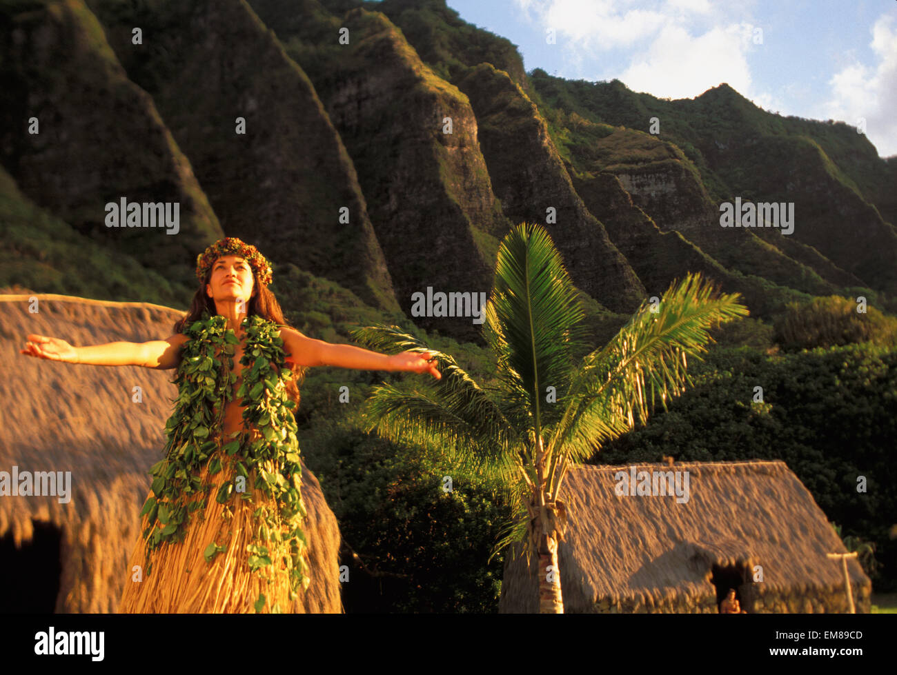 Hawaii, Oahu, Woman Dancing Hula With Ko'olau Mountains, Grass Shacks ...