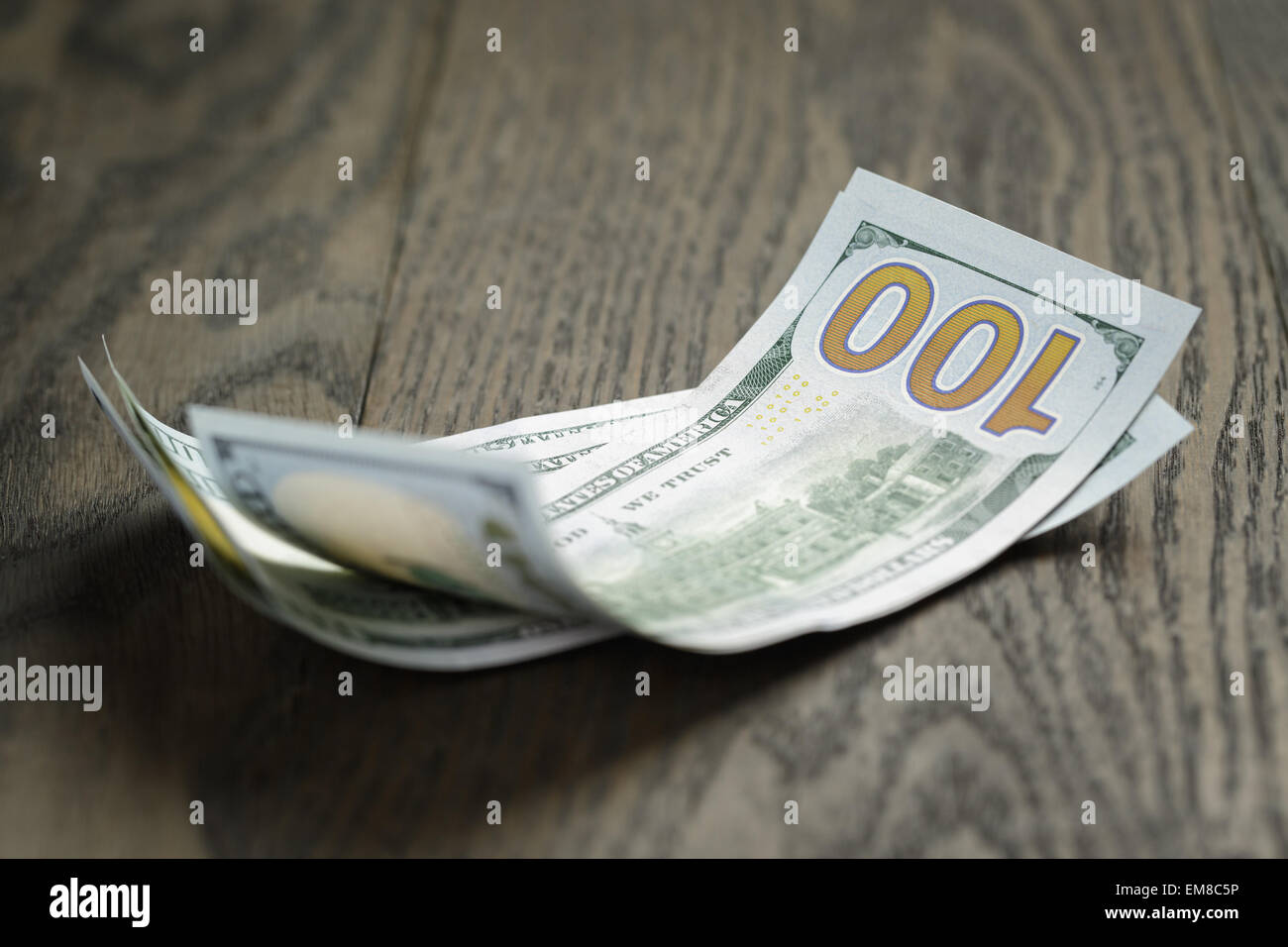 new hundred dollar bills on wood table Stock Photo - Alamy