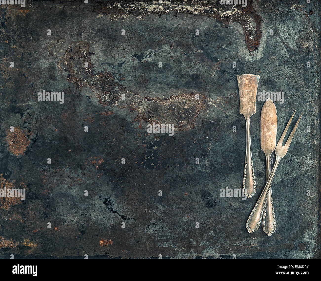 Antique silver cutlery on rustic metal background. Vintage tableware ...