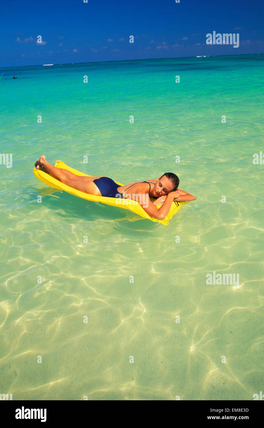 Full Length View Of Woman Laying On Yellow Raft, Floating Shallow Ocean ...