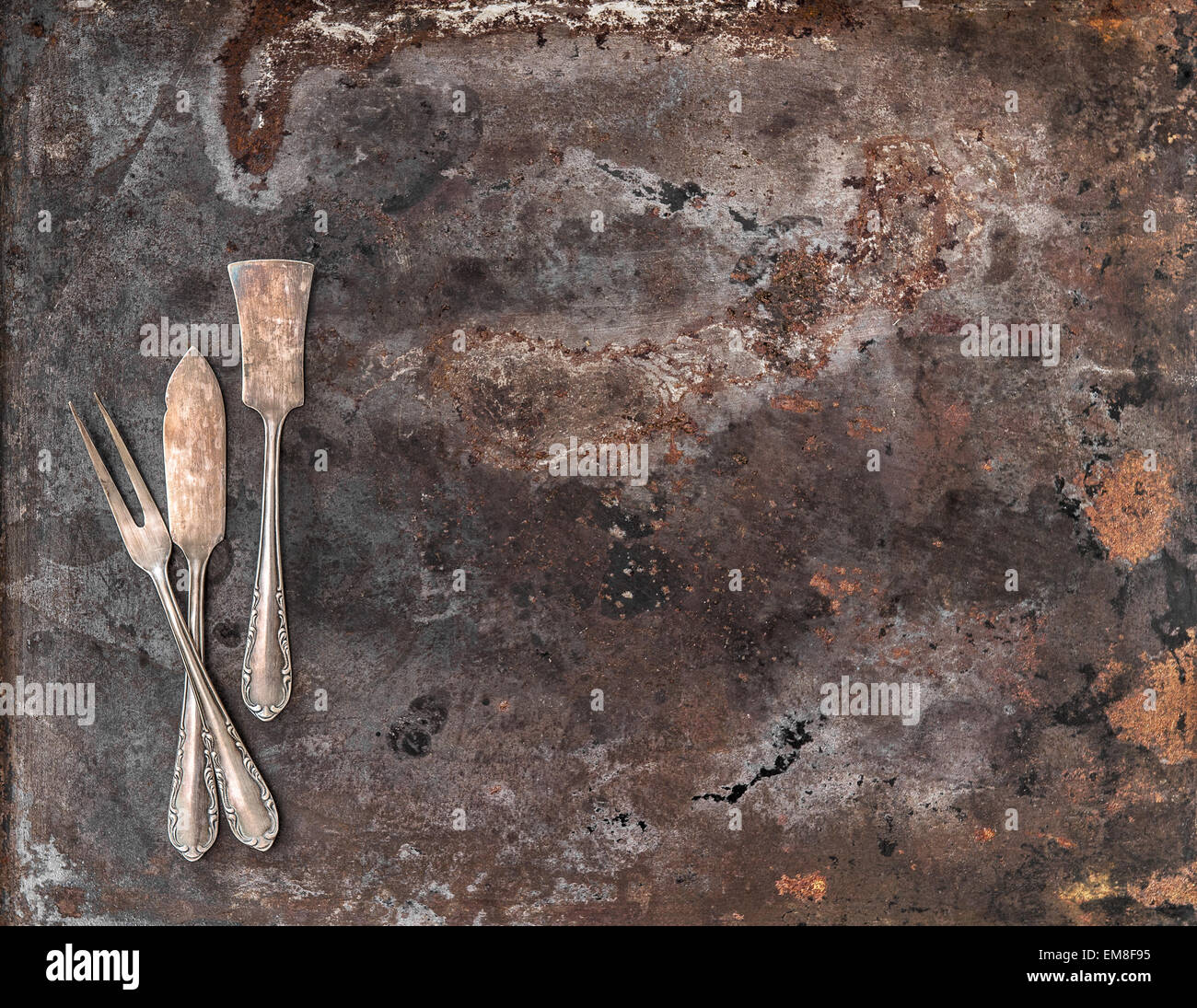 Vintage silver cutlery on rustic textured metal background. Antique ...