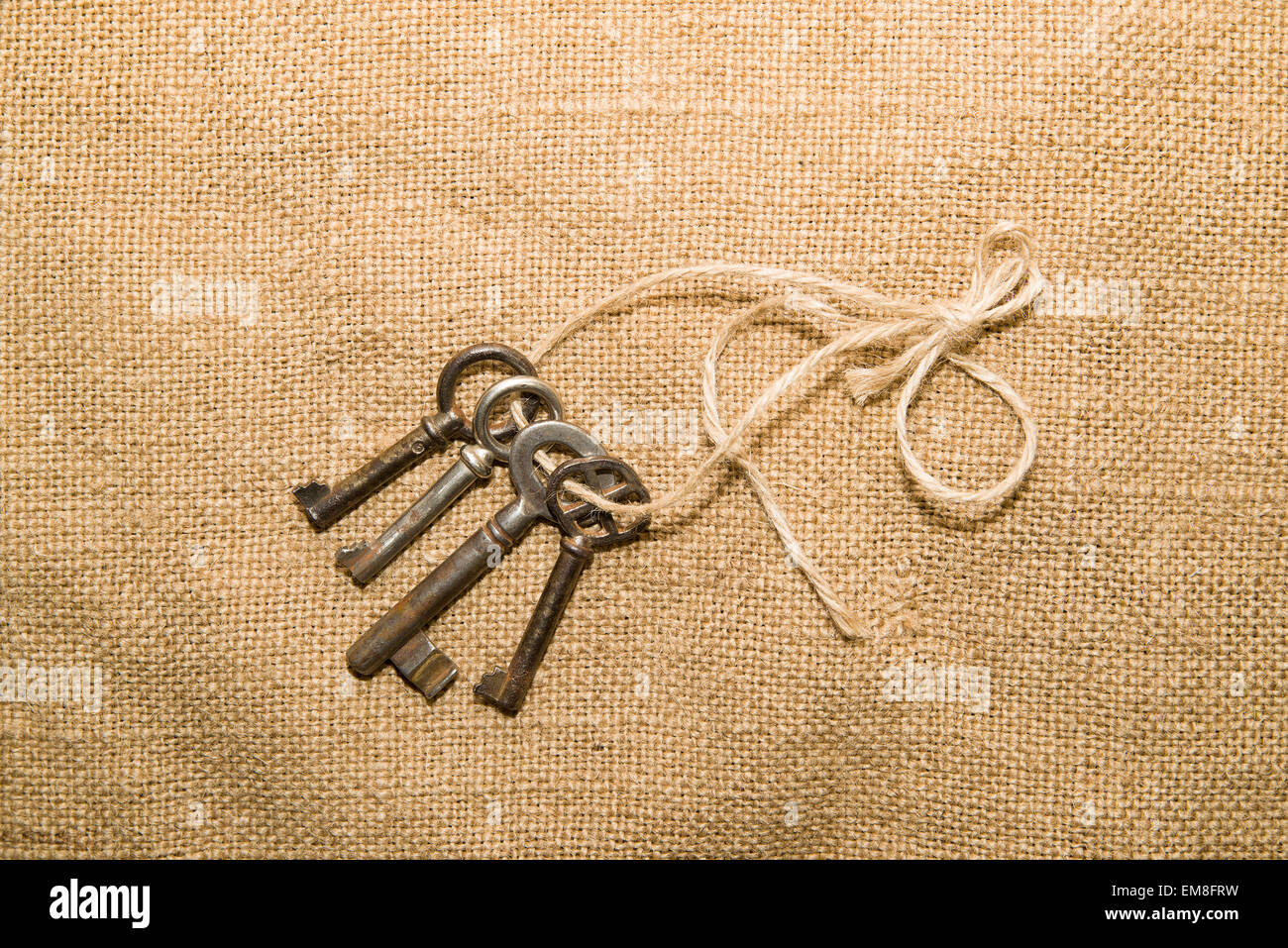 Four old keys tied with a rope on old cloth Stock Photo - Alamy