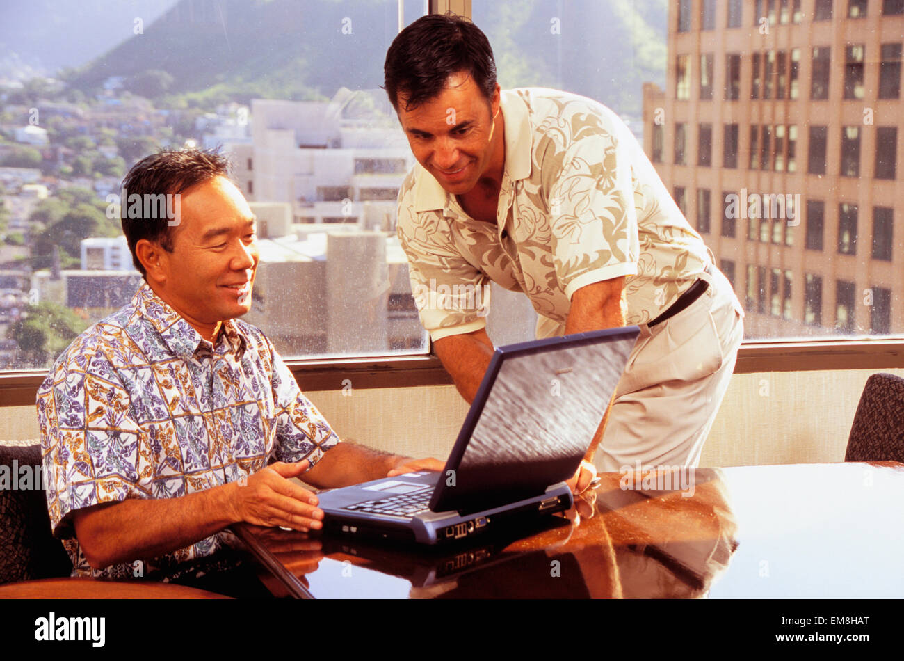Two Local Businessman Viewing Computer Screen Stock Photo - Alamy