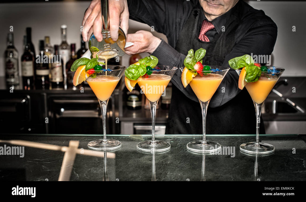 Barman pouring cocktails, mid section Stock Photo - Alamy