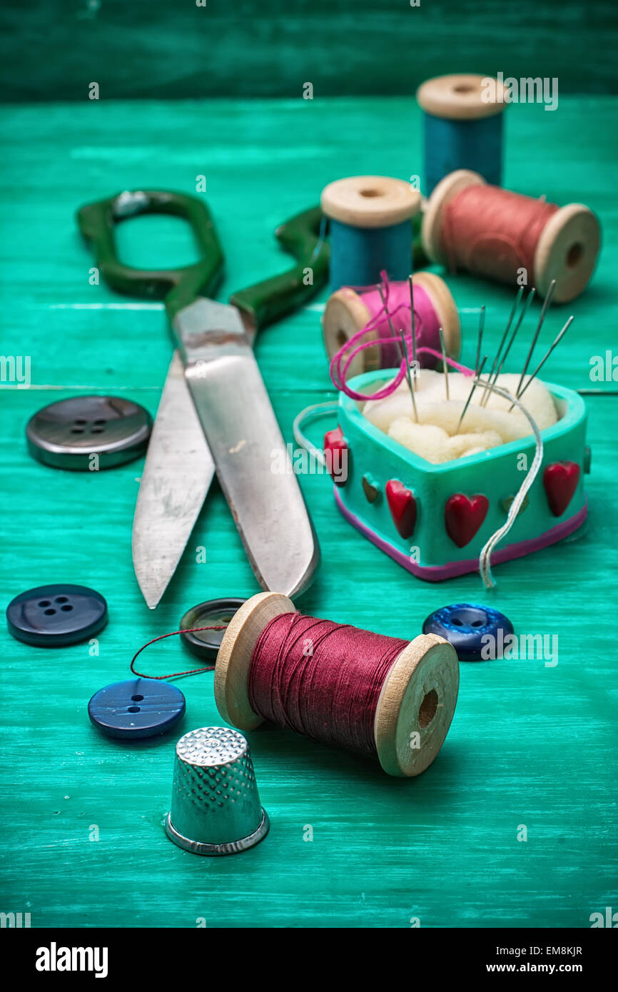 thread buttons for crafts on turquoise wooden background.Selective ...