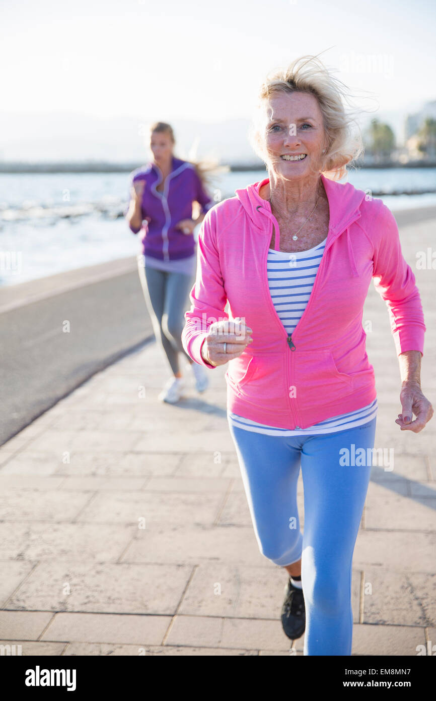 Women jogging by beach Stock Photo - Alamy