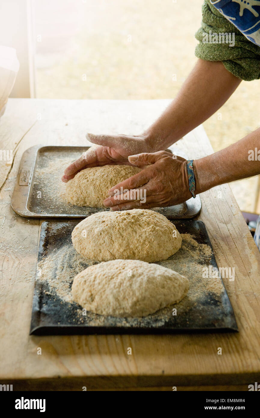 Mature man making organic bread, focus on hands and bread Stock Photo ...