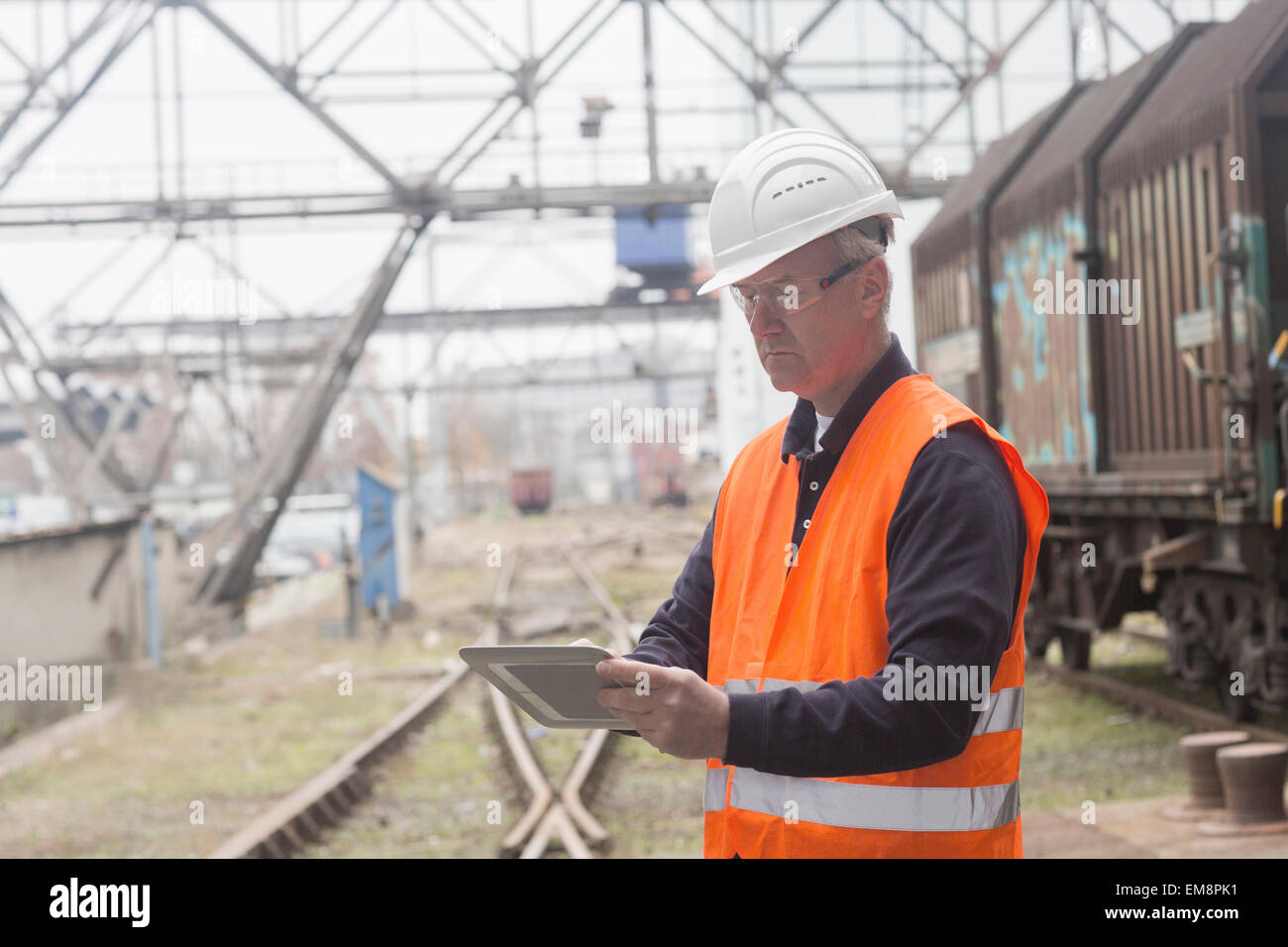 Dock worker using digital tablet at port Stock Photo - Alamy