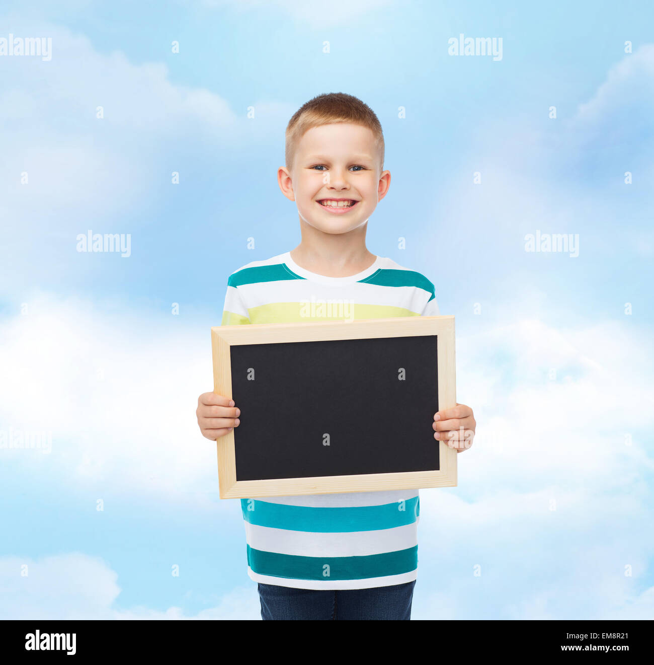 smiling little boy holding blank black chalkboard Stock Photo - Alamy