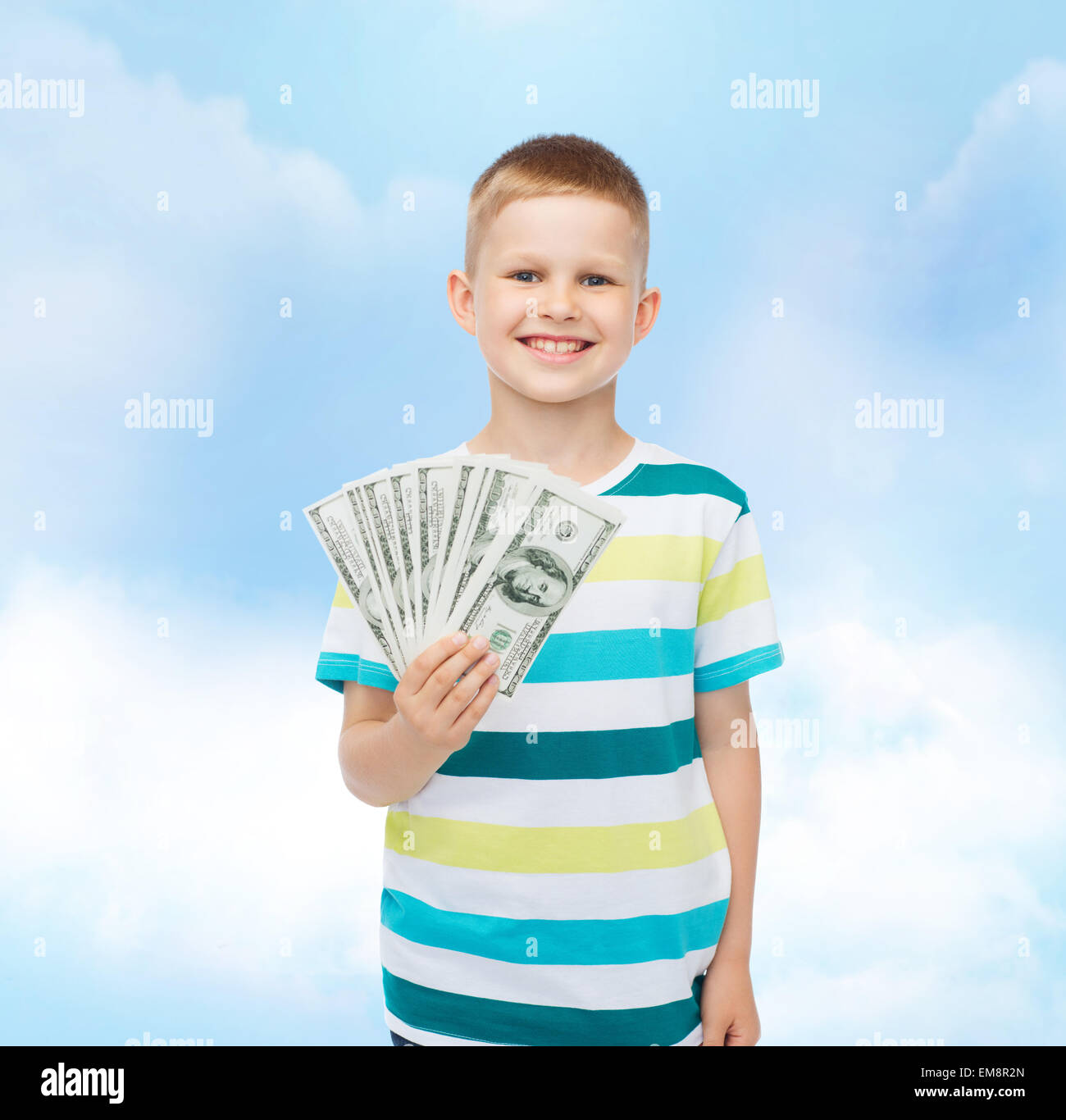 smiling boy holding dollar cash money in his hand Stock Photo - Alamy
