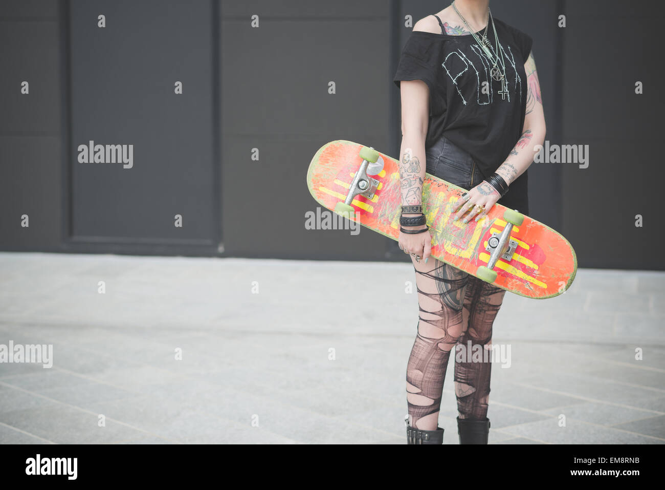 Cropped shot of young female punk holding skateboard Stock Photo - Alamy
