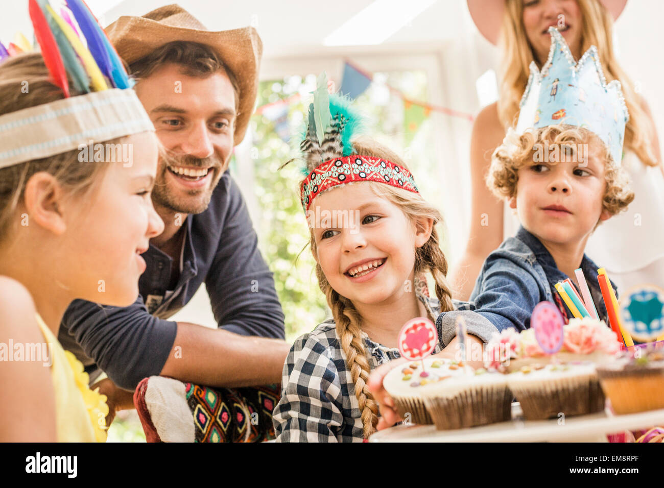 Parents and children at kids birthday party Stock Photo - Alamy