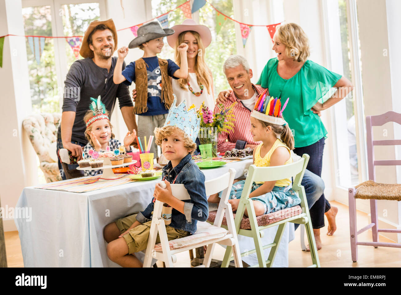 Portrait of three generation family at kids birthday party Stock Photo ...