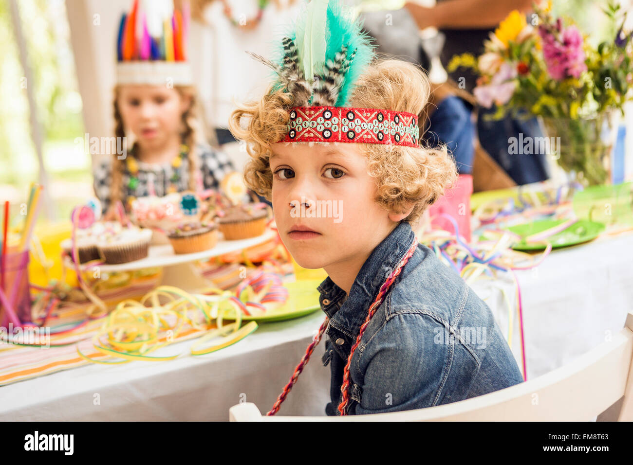 Portrait of serious looking boy at kids birthday party Stock Photo - Alamy
