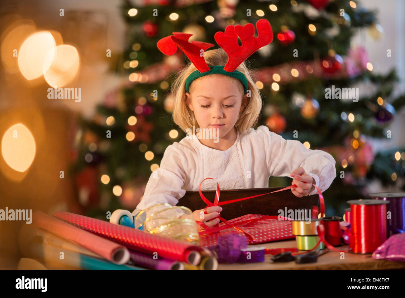 Girl wrapping Christmas presents Stock Photo - Alamy