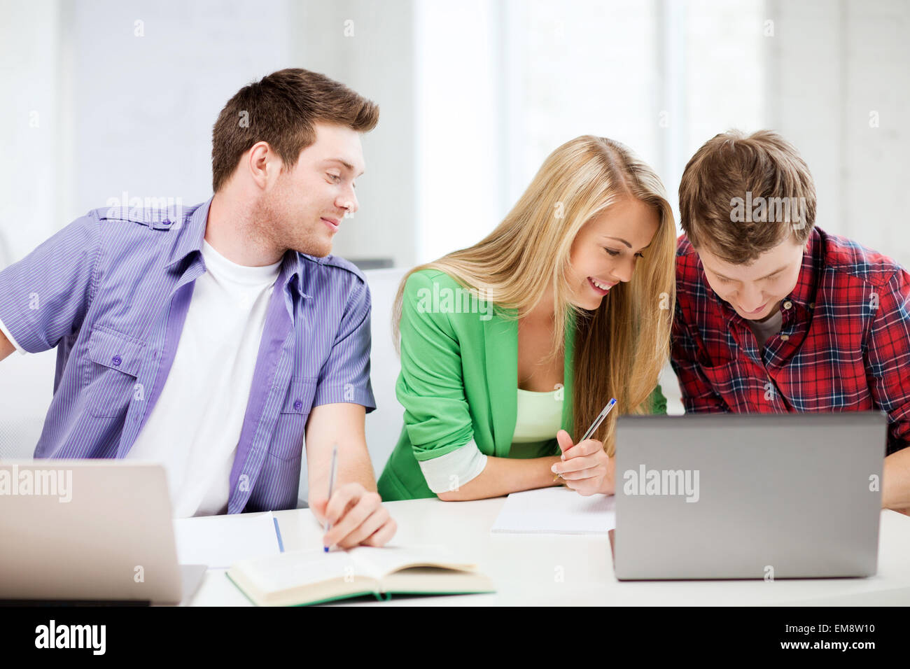 students writing something at school Stock Photo - Alamy