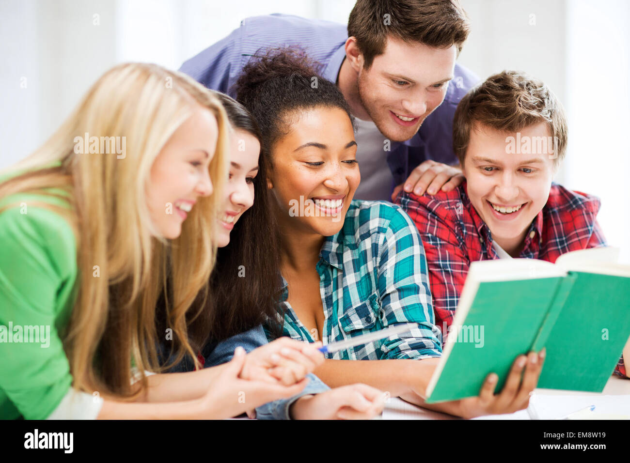 students reading book at school Stock Photo - Alamy