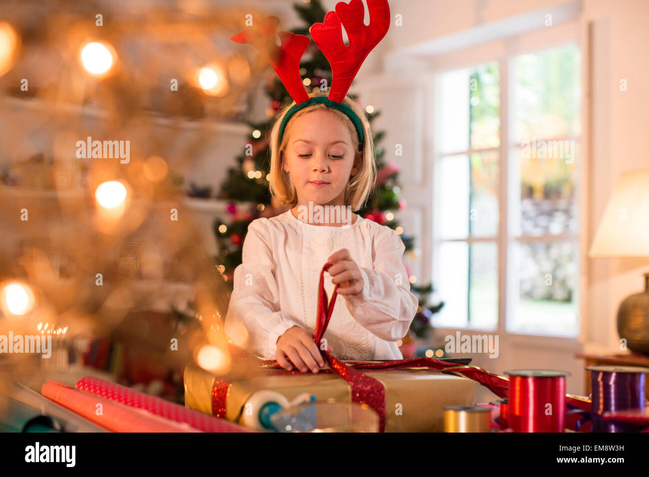Girl wrapping Christmas presents Stock Photo - Alamy