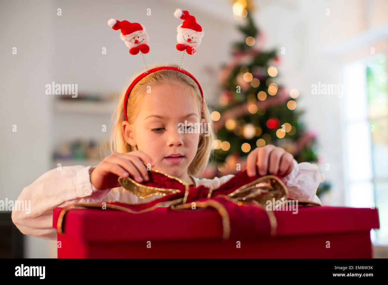 Girl wrapping Christmas presents Stock Photo - Alamy