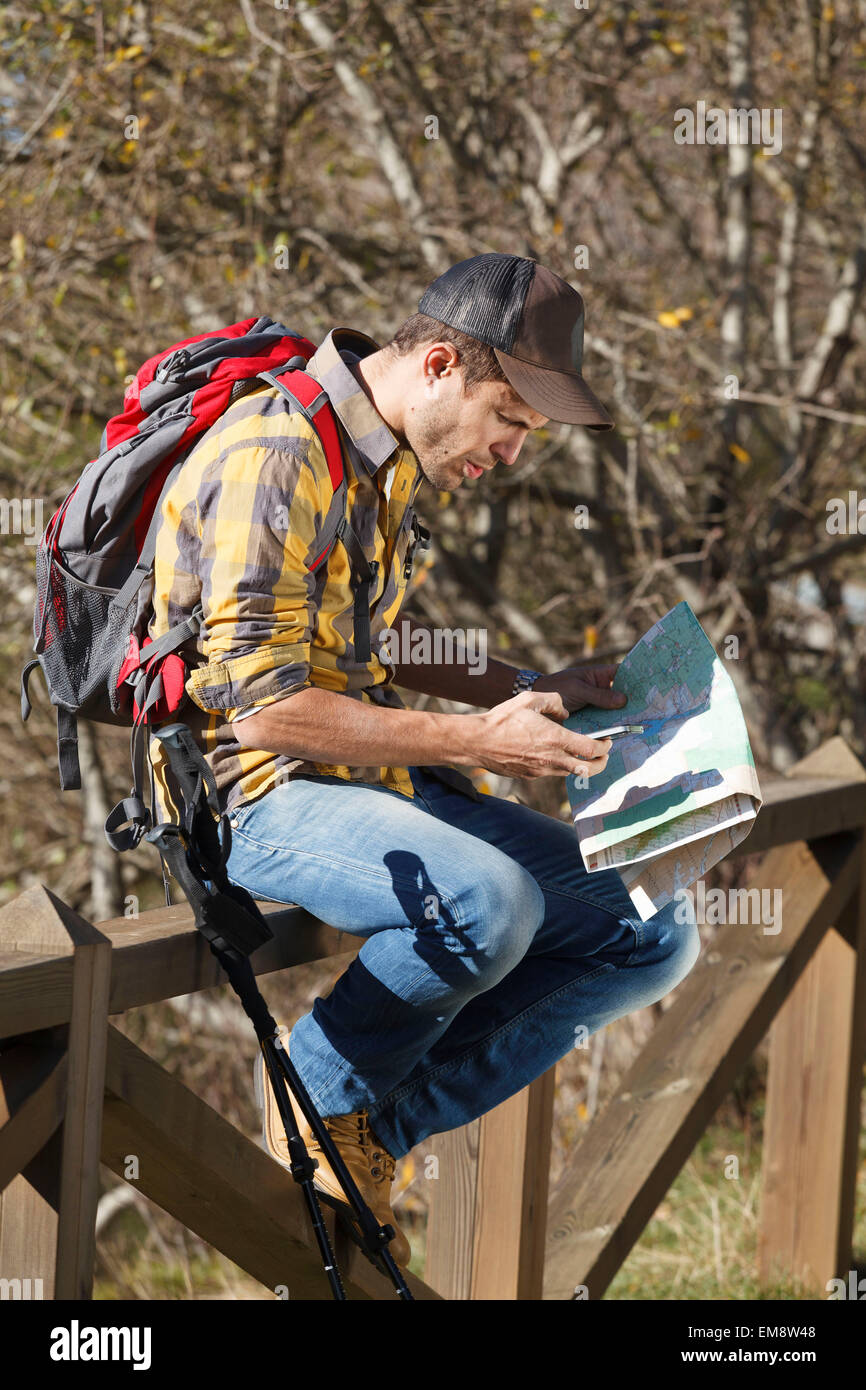 Hiker reading map on wooden handrail, Montseny, Barcelona, Catalonia ...