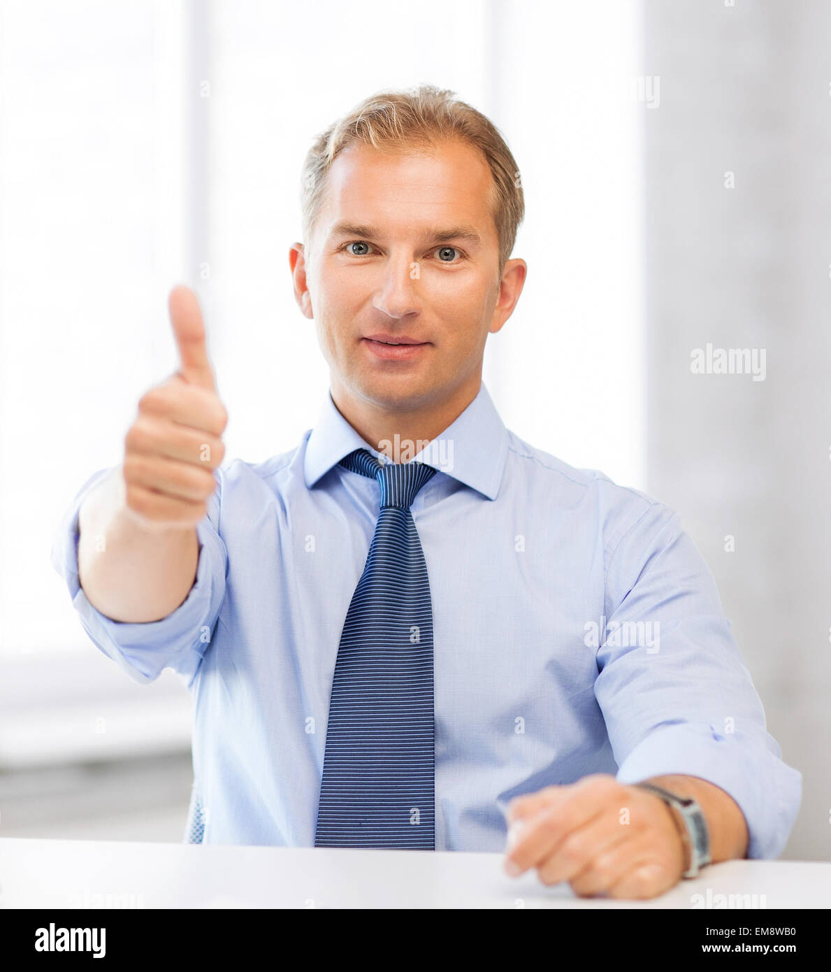 smiling businessman showing thumbs up Stock Photo - Alamy