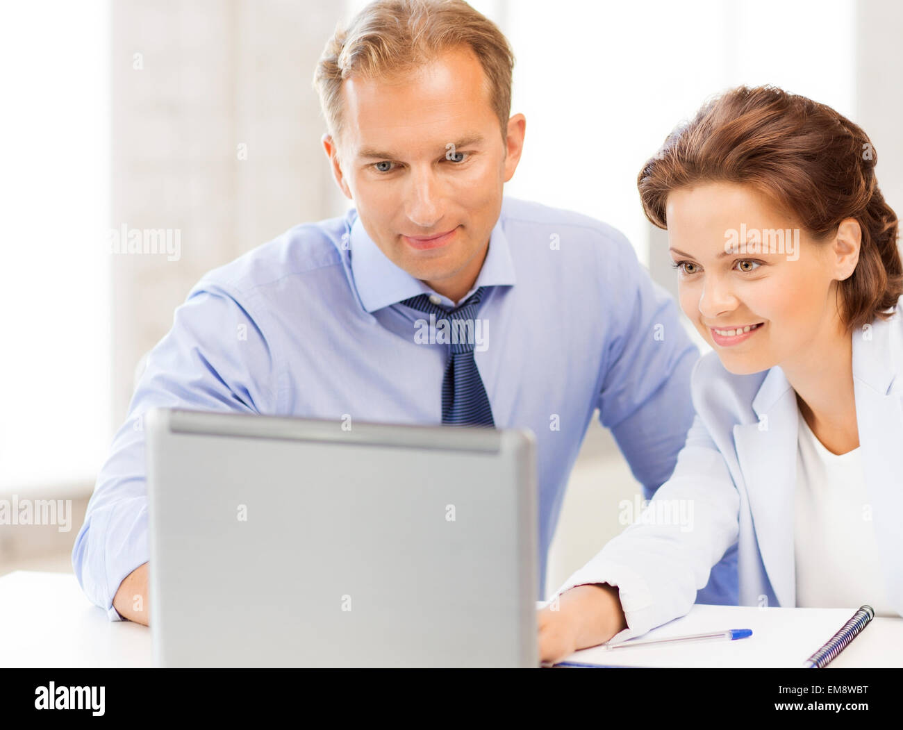 man and woman working with laptop in office Stock Photo - Alamy