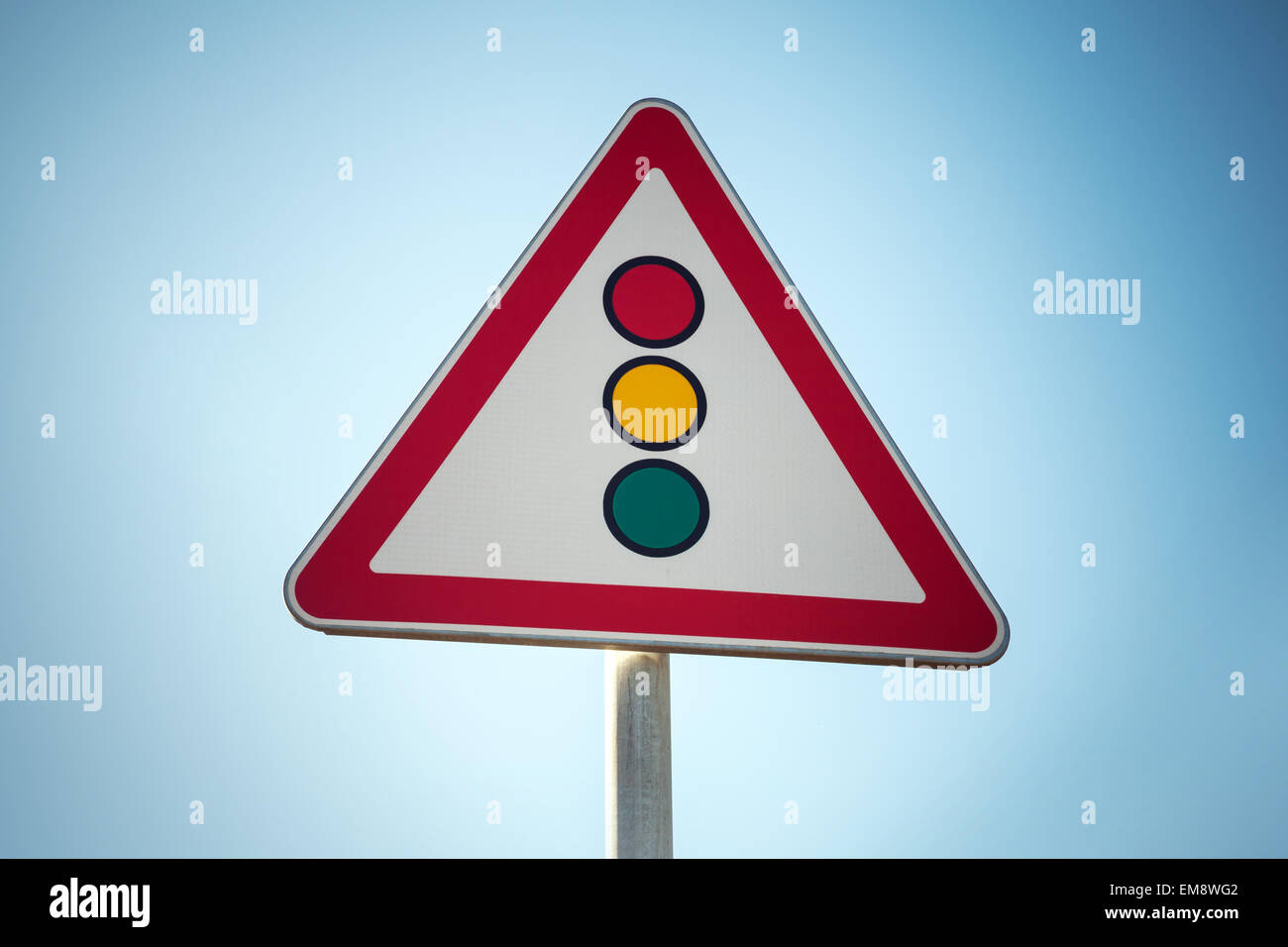 Traffic lights. Triangle road sign over blue sky background. Photo with ...