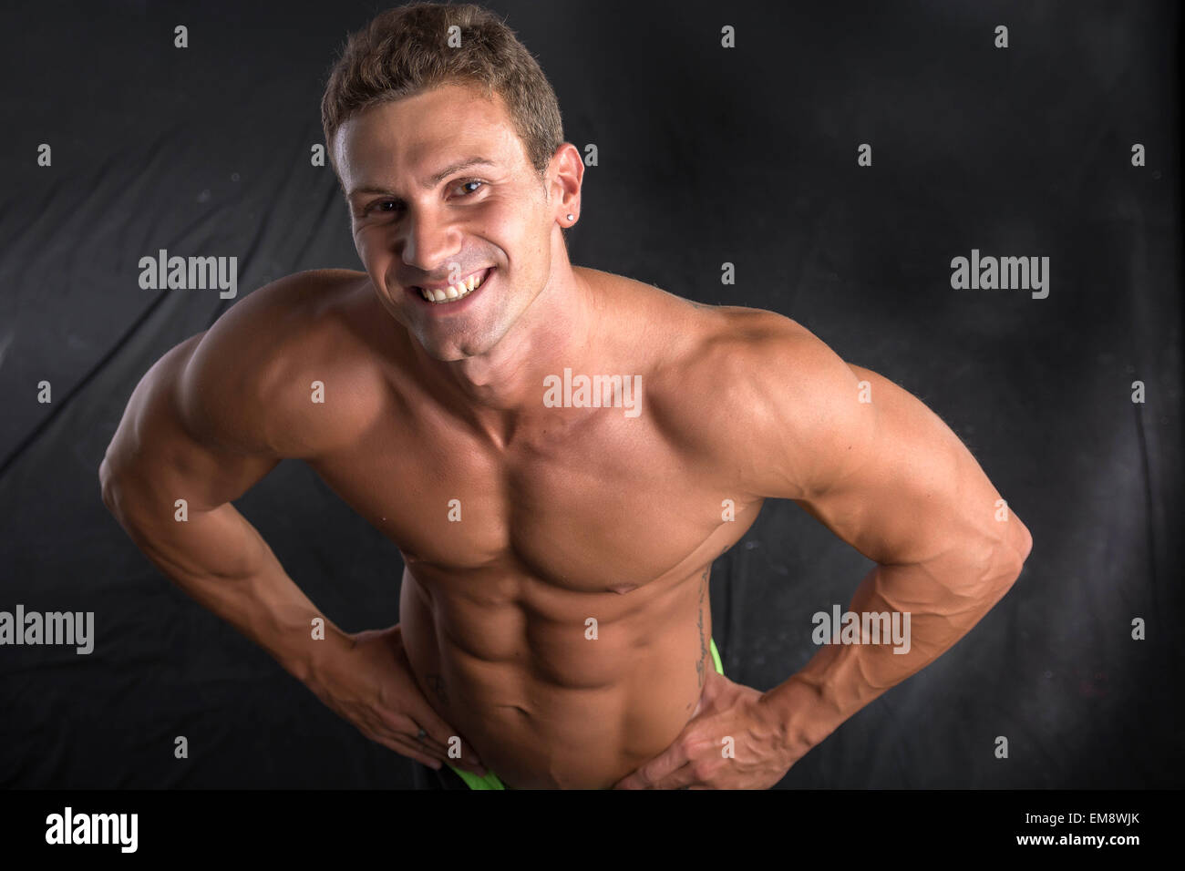 Handsome shirtless bodybuilder shot from above, standing Stock Photo ...