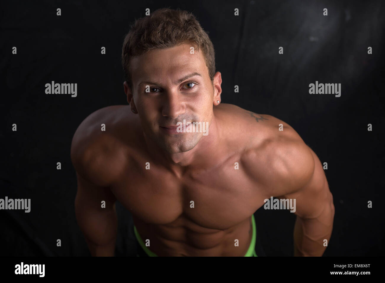 Handsome shirtless bodybuilder shot from above, standing Stock Photo ...