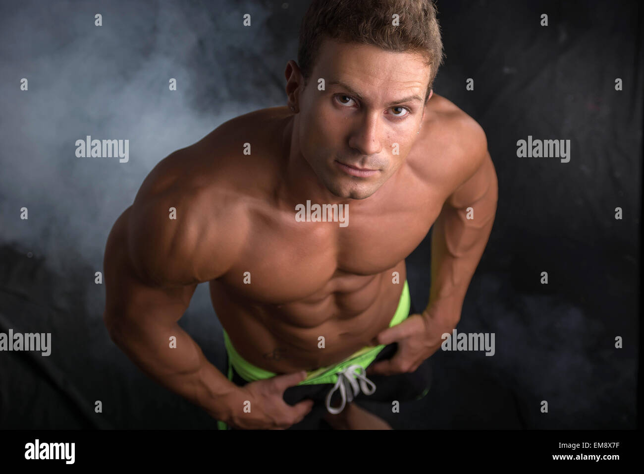 Handsome shirtless bodybuilder shot from above, standing Stock Photo ...