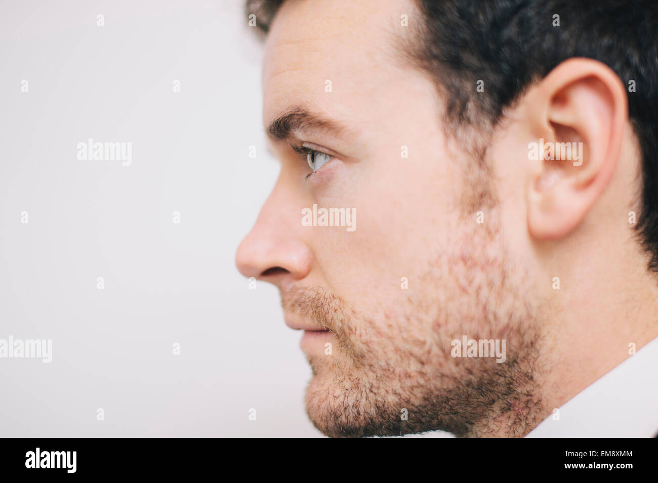Close up profile portrait of young man staring ahead Stock Photo - Alamy