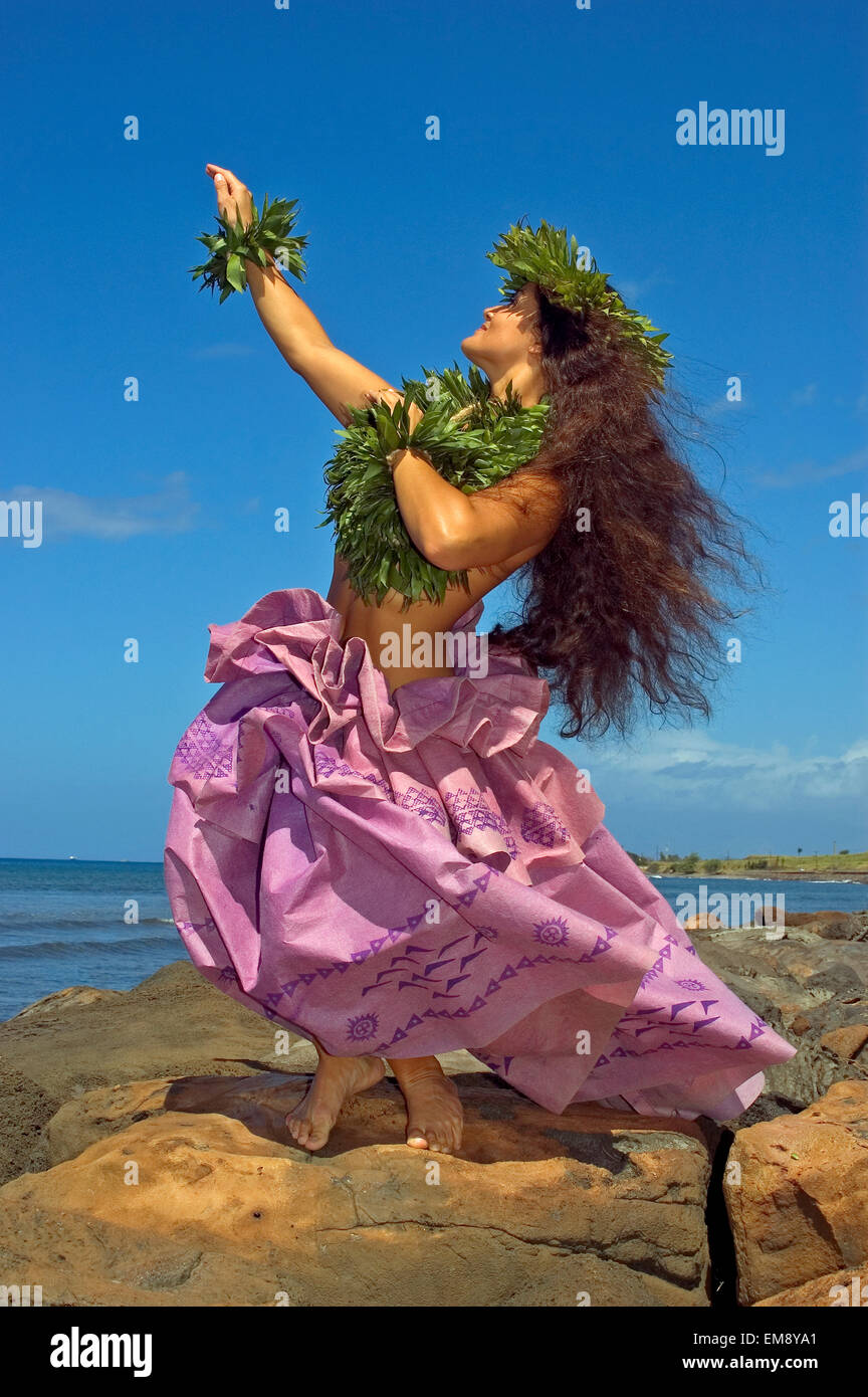 Hula Dancer With Haku Lei In Traditional Outfit On Rocky Coast, Ocean ...
