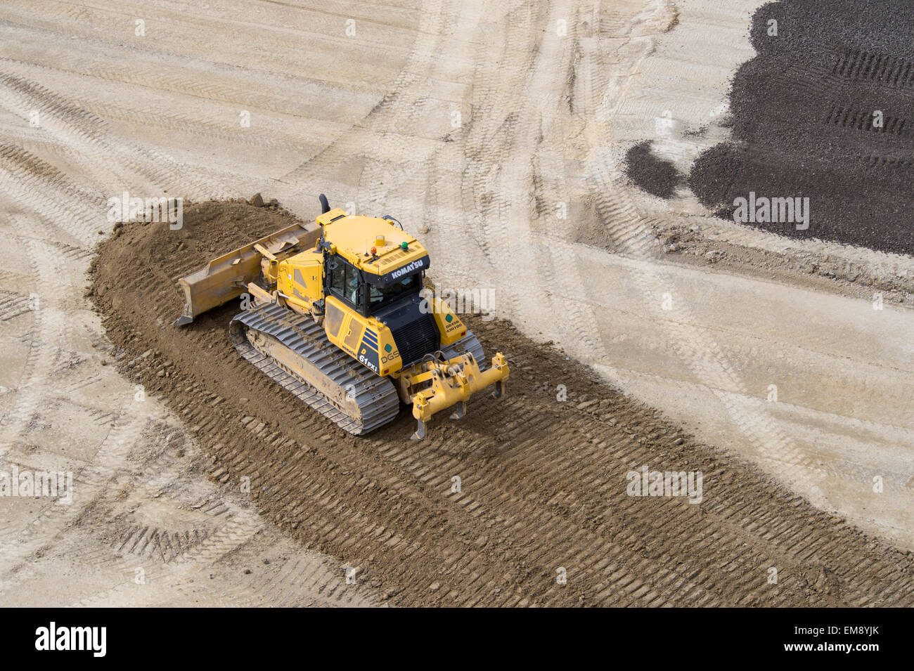 low level aerial view of digger clearing soil on consruction site Stock ...