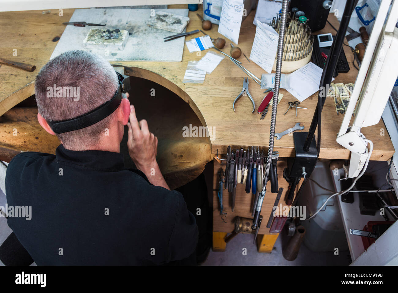 Overhead view of jewellery craftsman at workbench Stock Photo - Alamy