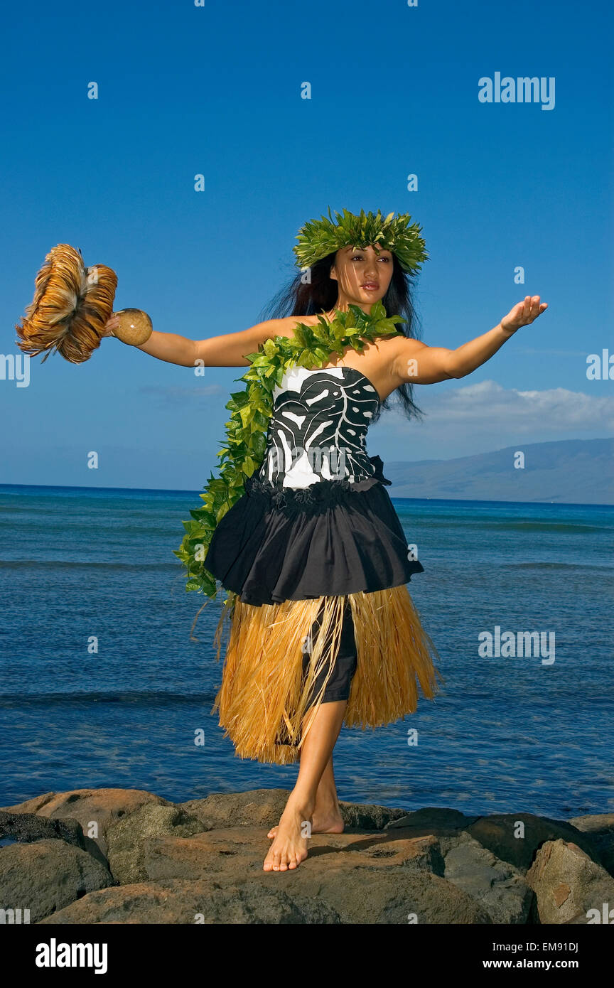 Hula Dancer With Haku Lei In Traditional Outfit On Rocky Coast Holding ...