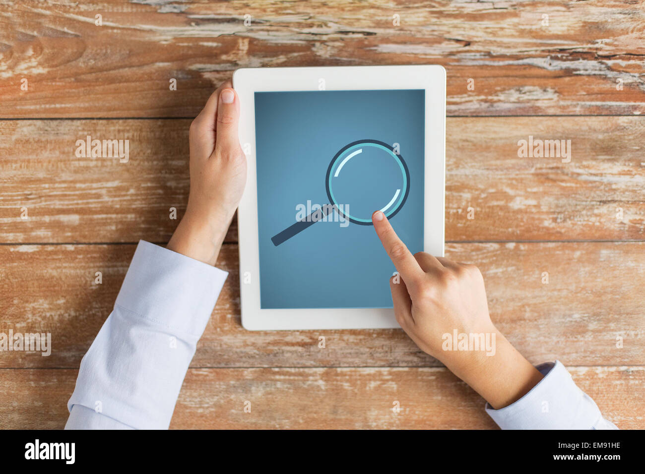 close up of male hands with magnifier on tablet pc Stock Photo - Alamy