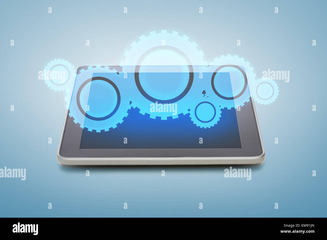 tablet pc with cogwheel icon over screen Stock Photo - Alamy