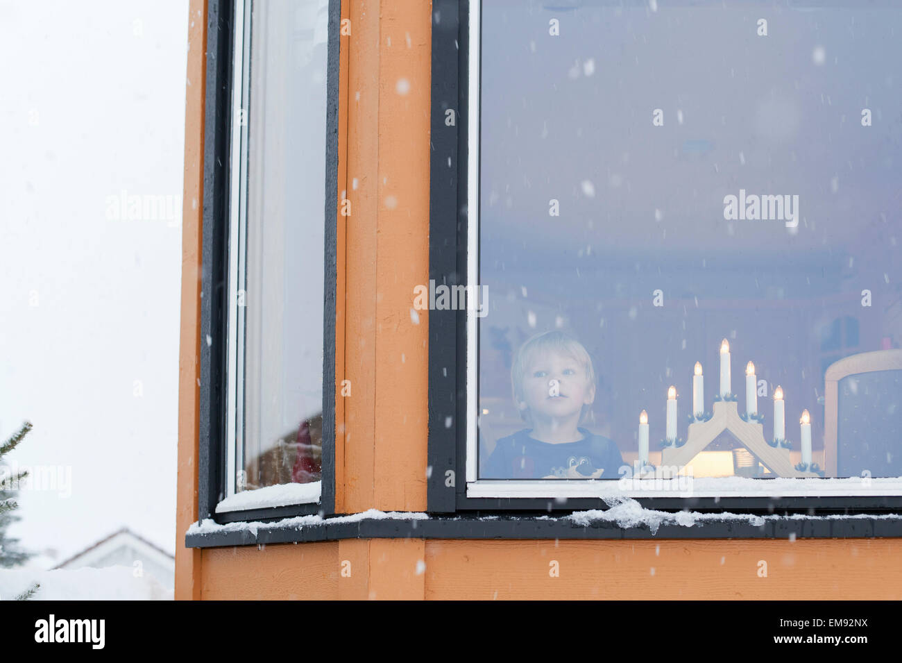 Boy waiting behind window Stock Photo - Alamy