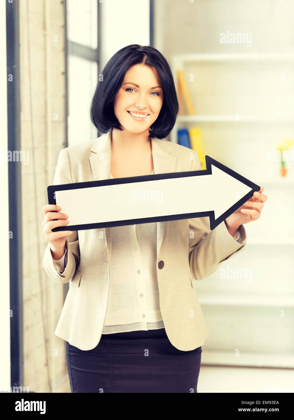 businesswoman with direction arrow sign Stock Photo - Alamy