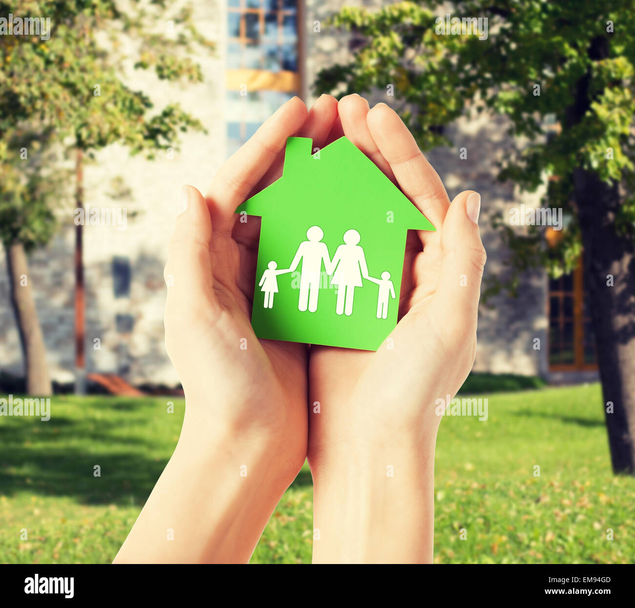 hands holding green house with family Stock Photo - Alamy
