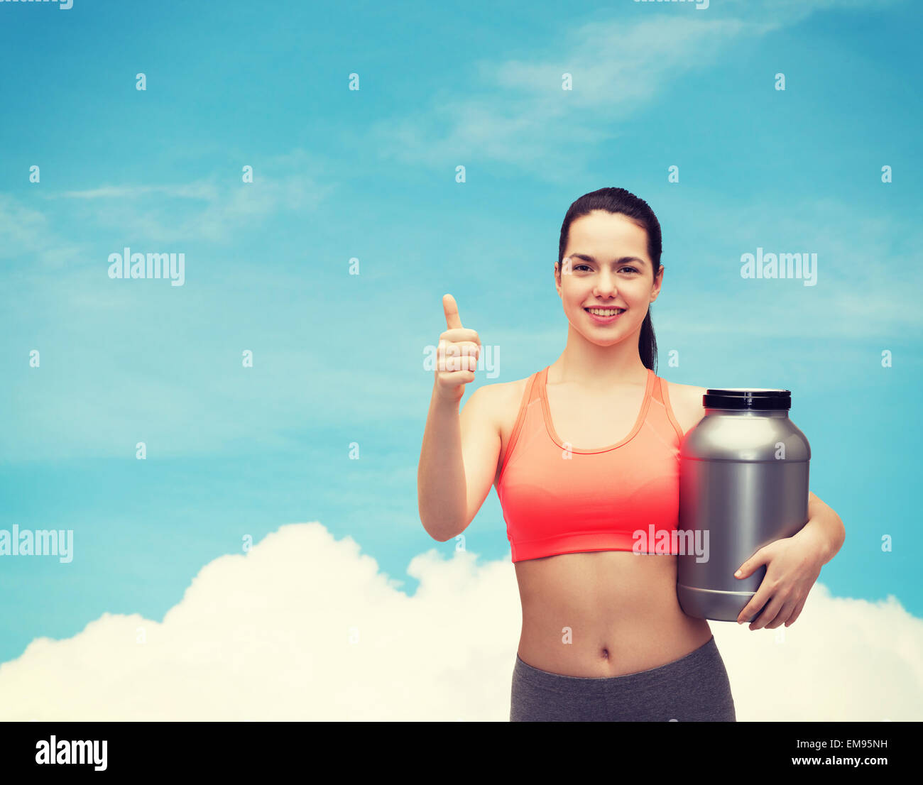 teenage girl with jar of protein showing thumbs up Stock Photo - Alamy